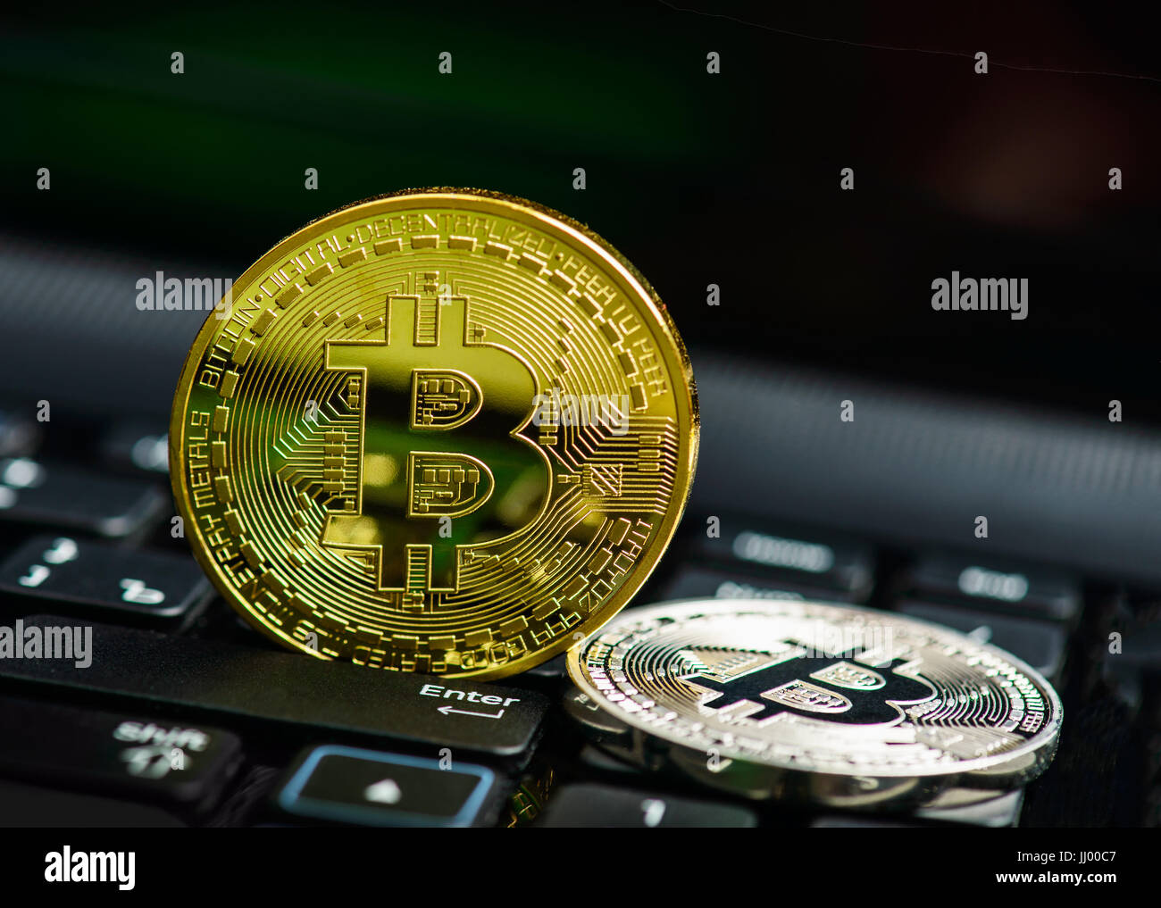 bitcoin coins on black keyboard Stock Photo - Alamy