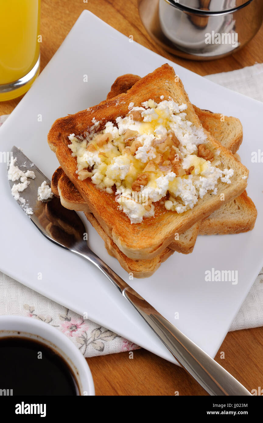 Crisp, fresh toast ricotta, honey and nuts for breakfast with orange ...