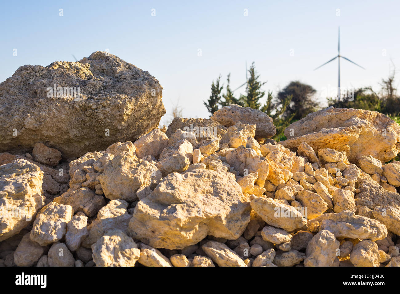 Stones and wind turbine on background Stock Photo - Alamy