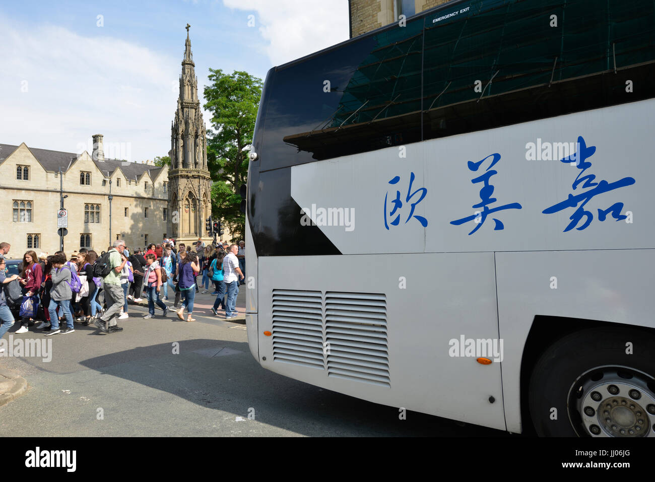 Tourist bus with Chinese lettering and logos deposits passengers in ...