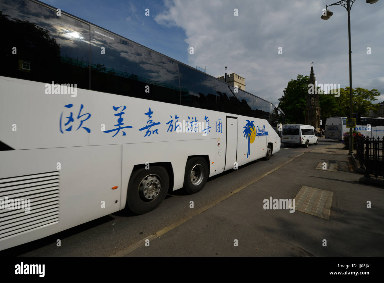 Tourist bus with Chinese lettering and logos deposits passengers in ...