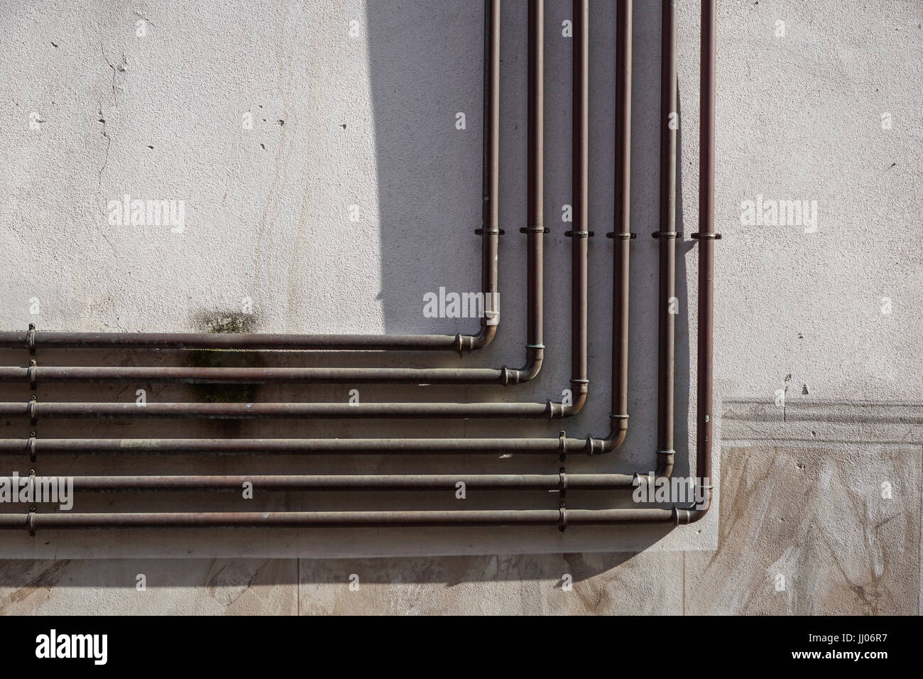 Metal gas pipe on in cement urban wall Stock Photo - Alamy