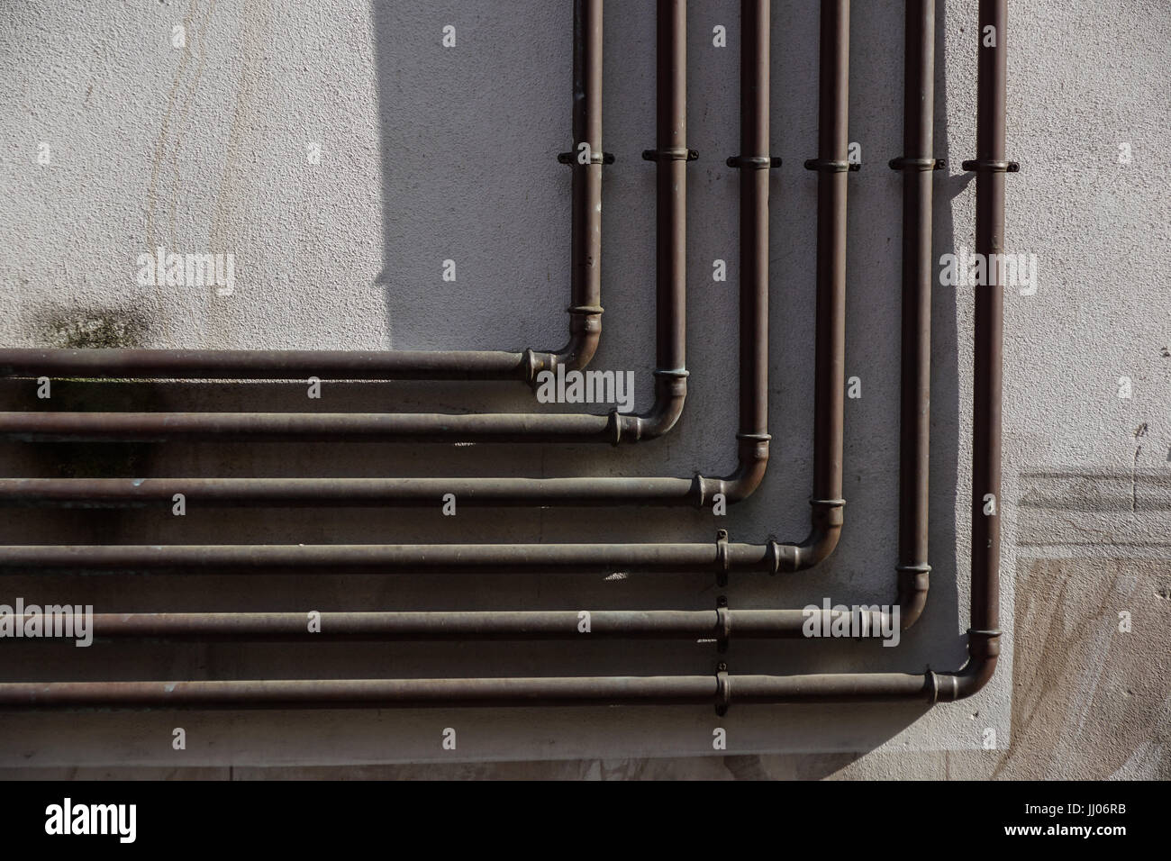 Metal gas pipe on in cement urban wall Stock Photo - Alamy