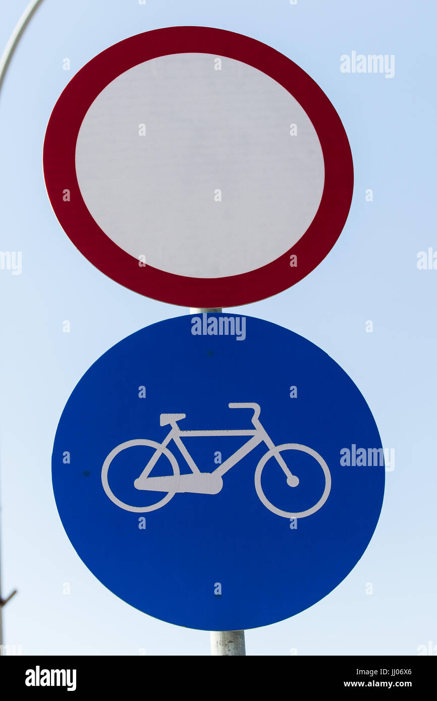 round bicycle lane sign against a blue sky Stock Photo - Alamy