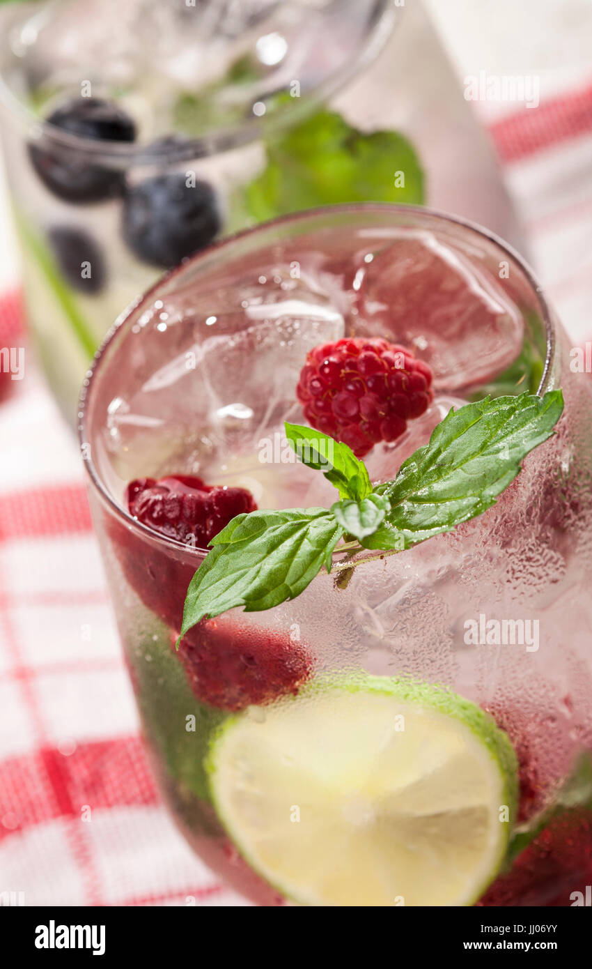 Summer cold drinks with raspberries, blueberries and blackberrries on ...