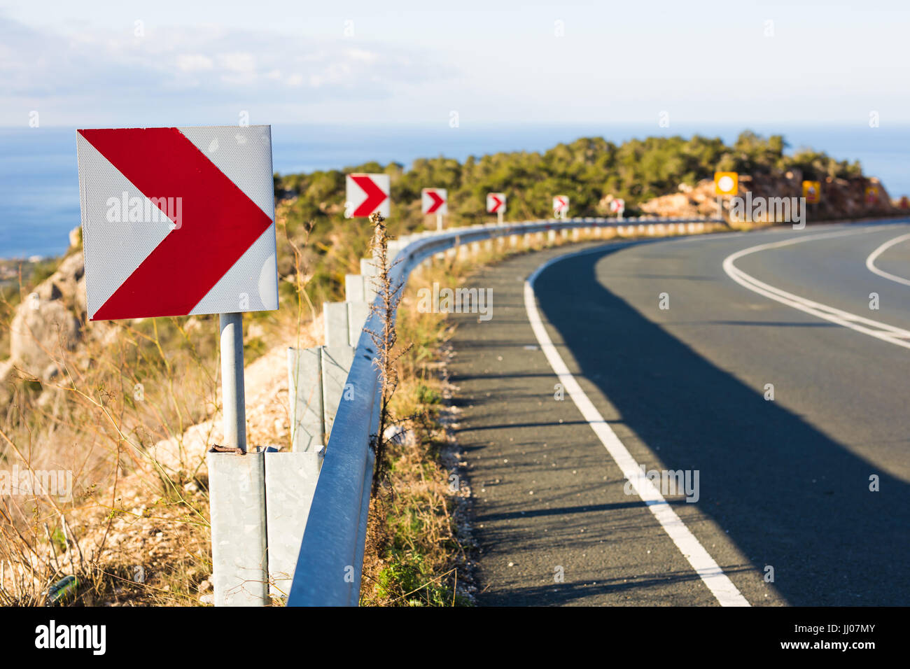 Right Turn Sign: Road signs warn of a sharp turn on a narrow road Stock ...