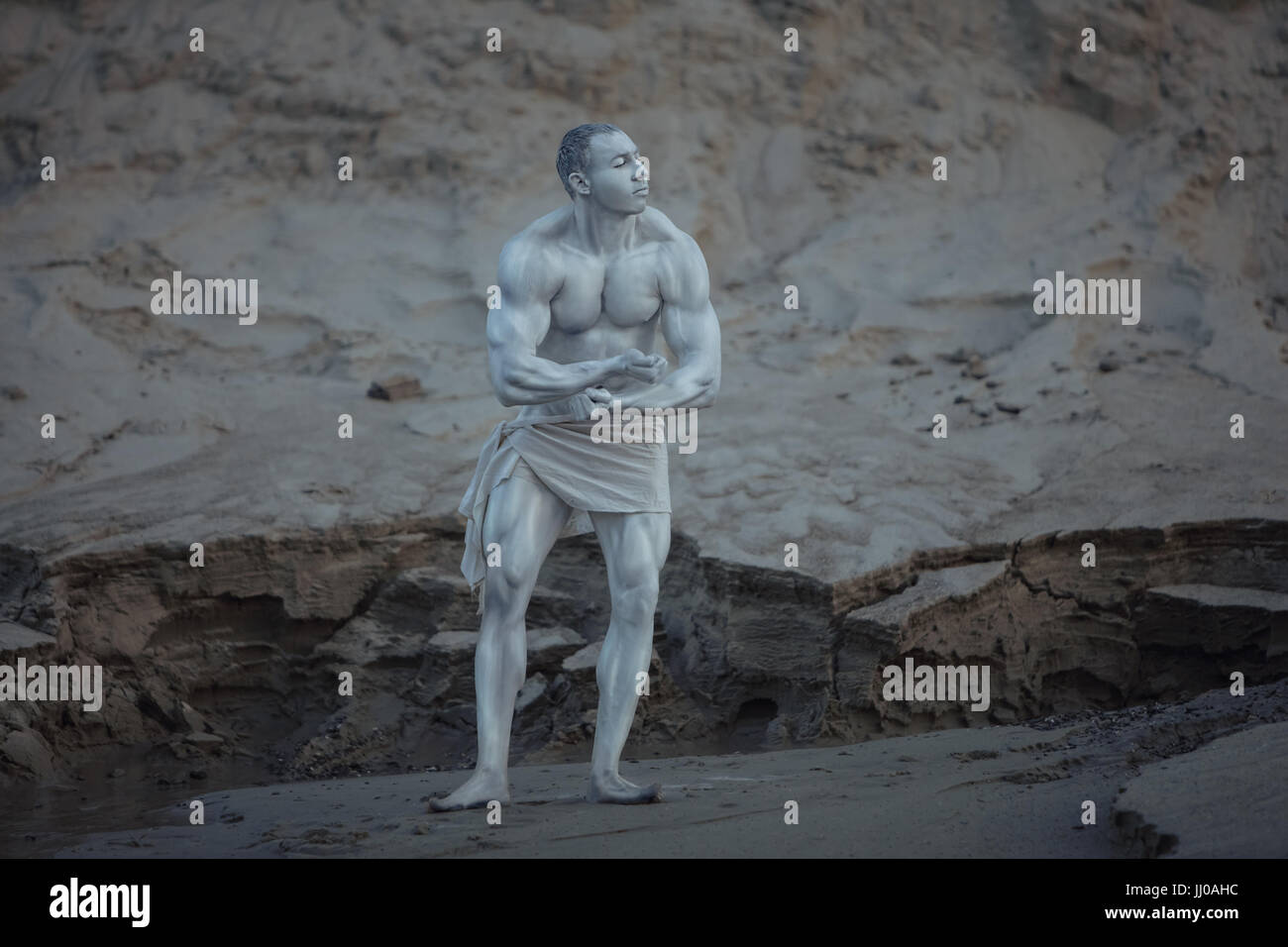 Male bodybuilder posing as a statue is made of stone Stock Photo - Alamy