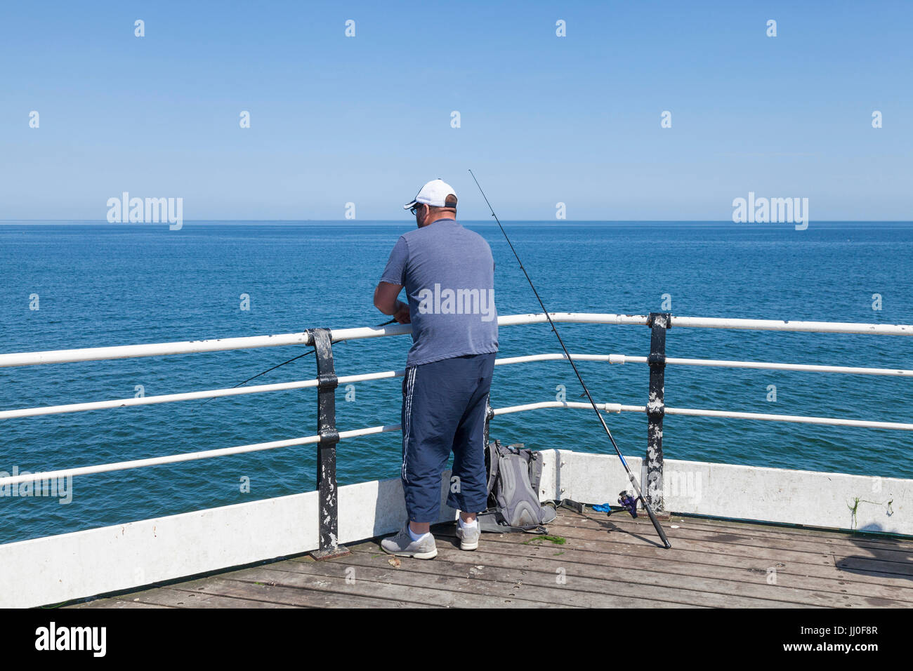 A man stood on the pier fishing at Saltburn by the Sea,England,UK Stock ...