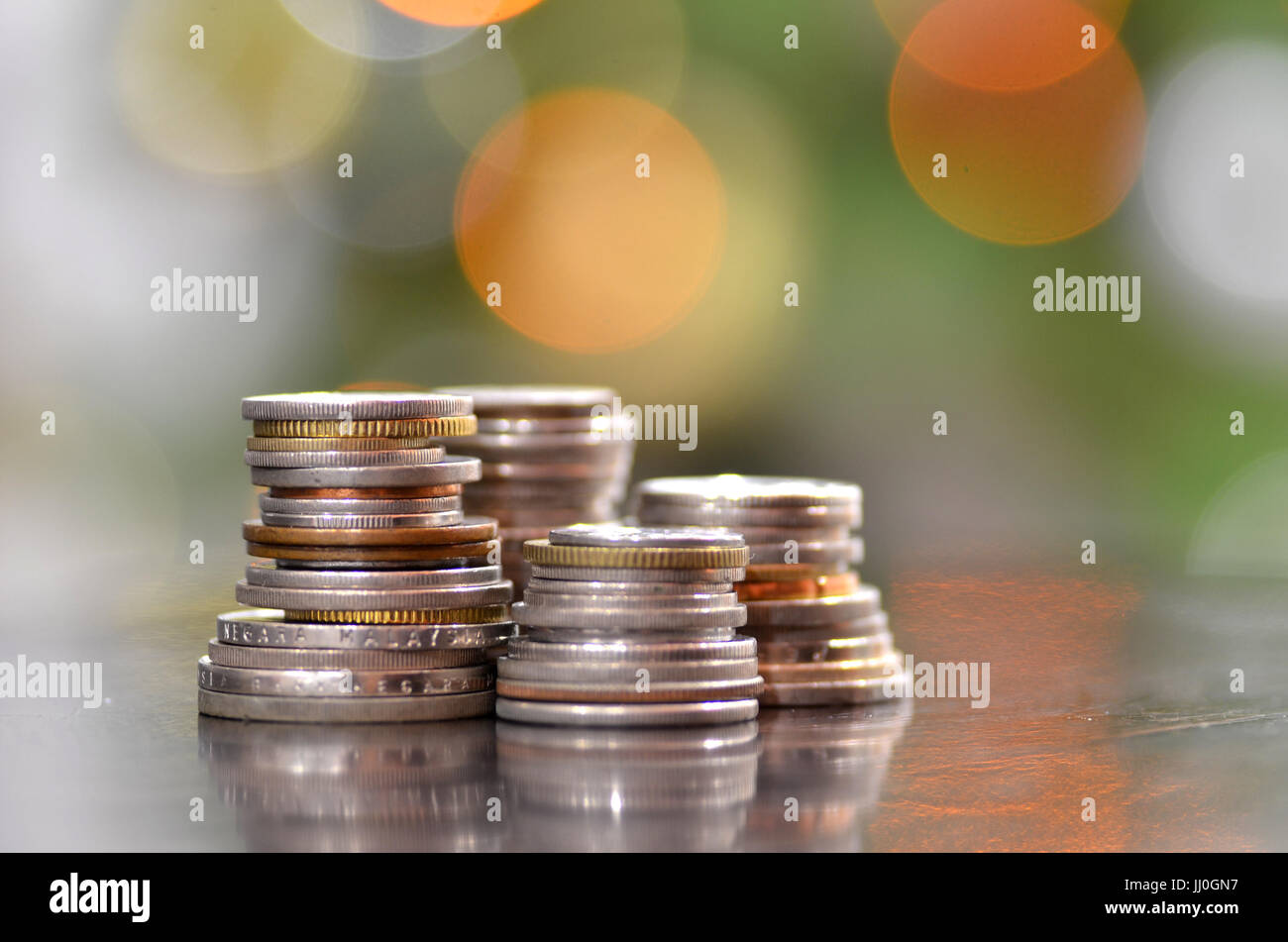 Mixed coins from many countries on wood table Stock Photo - Alamy