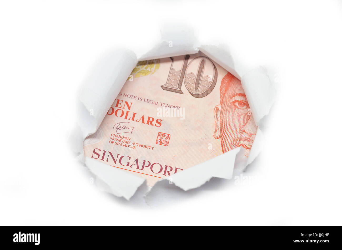 Singapore currency macro peeking through torn white paper Stock Photo ...