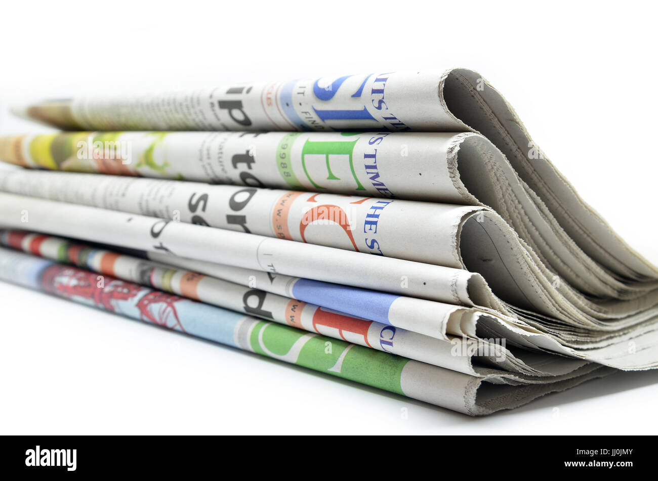 Newspapers folded and stacked isolated on white Stock Photo - Alamy