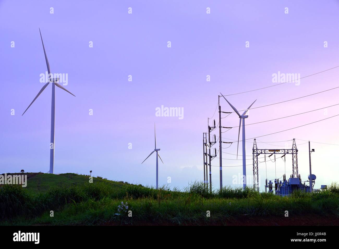 Wind turbine farm with power line and power plant during beautiful ...
