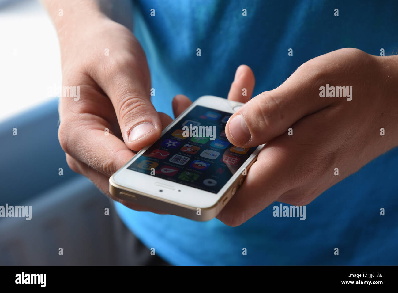 Close up of teenage boy using a Apple iPhone SE Stock Photo - Alamy