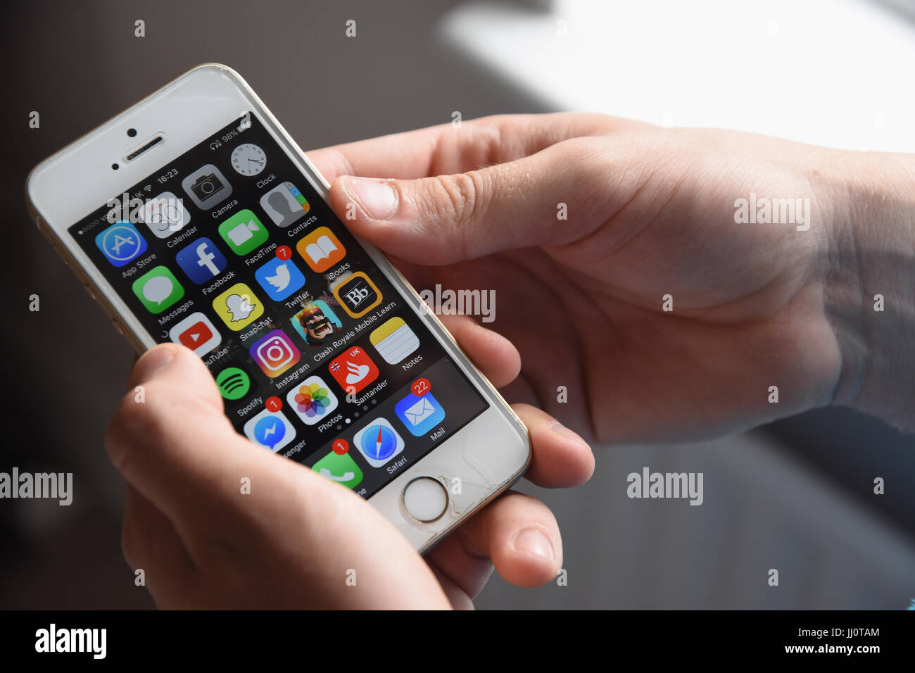 Boy holding iphone hi-res stock photography and images - Alamy