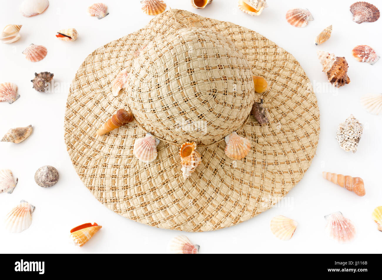 Home decorated woman straw hat with seashells surrounded by a variety ...