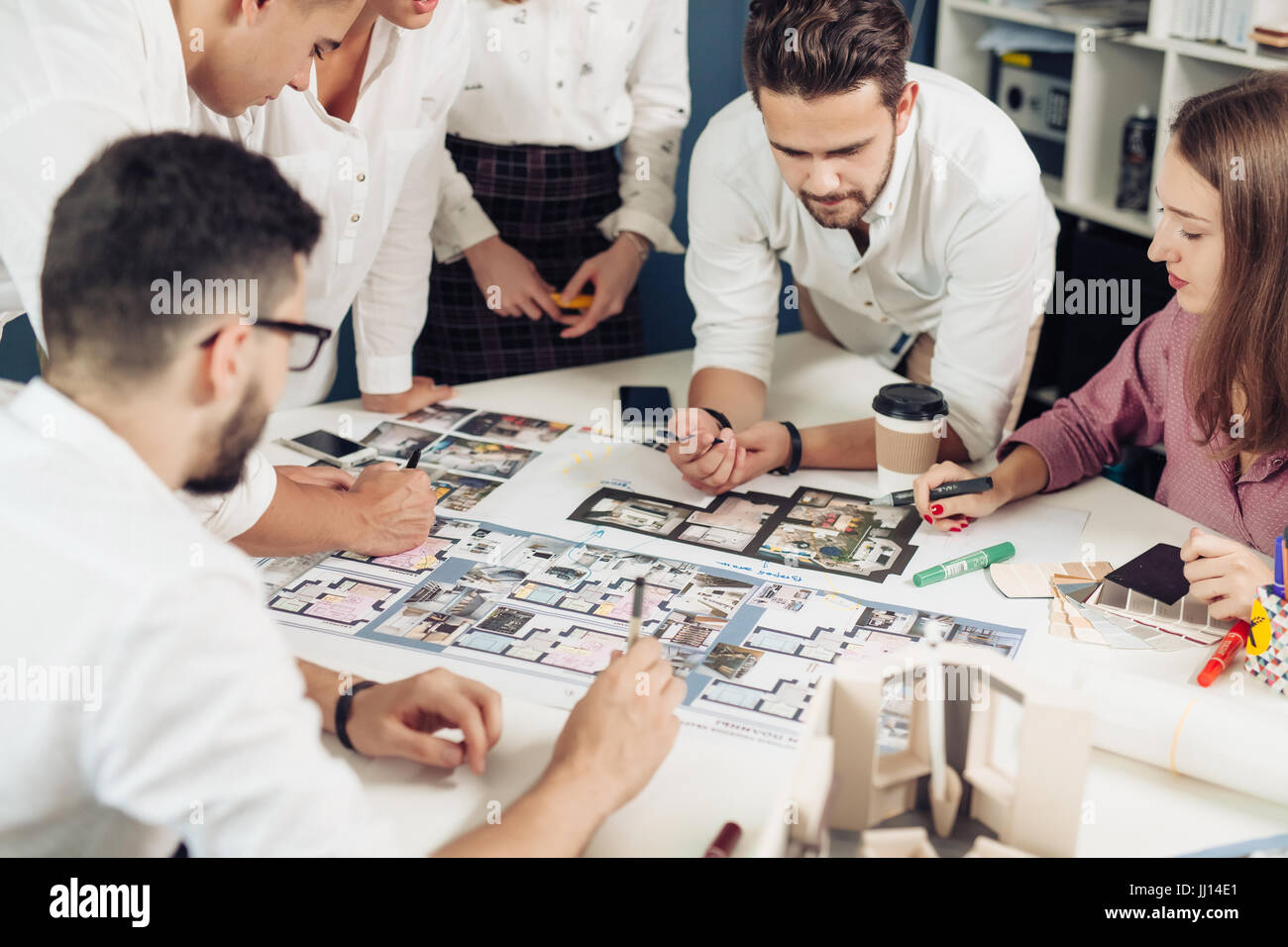 Team of architects working on construction plans Stock Photo - Alamy
