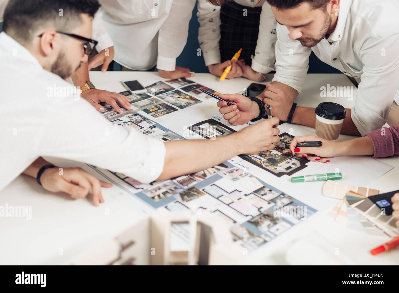 Team of architects working on construction plans Stock Photo - Alamy
