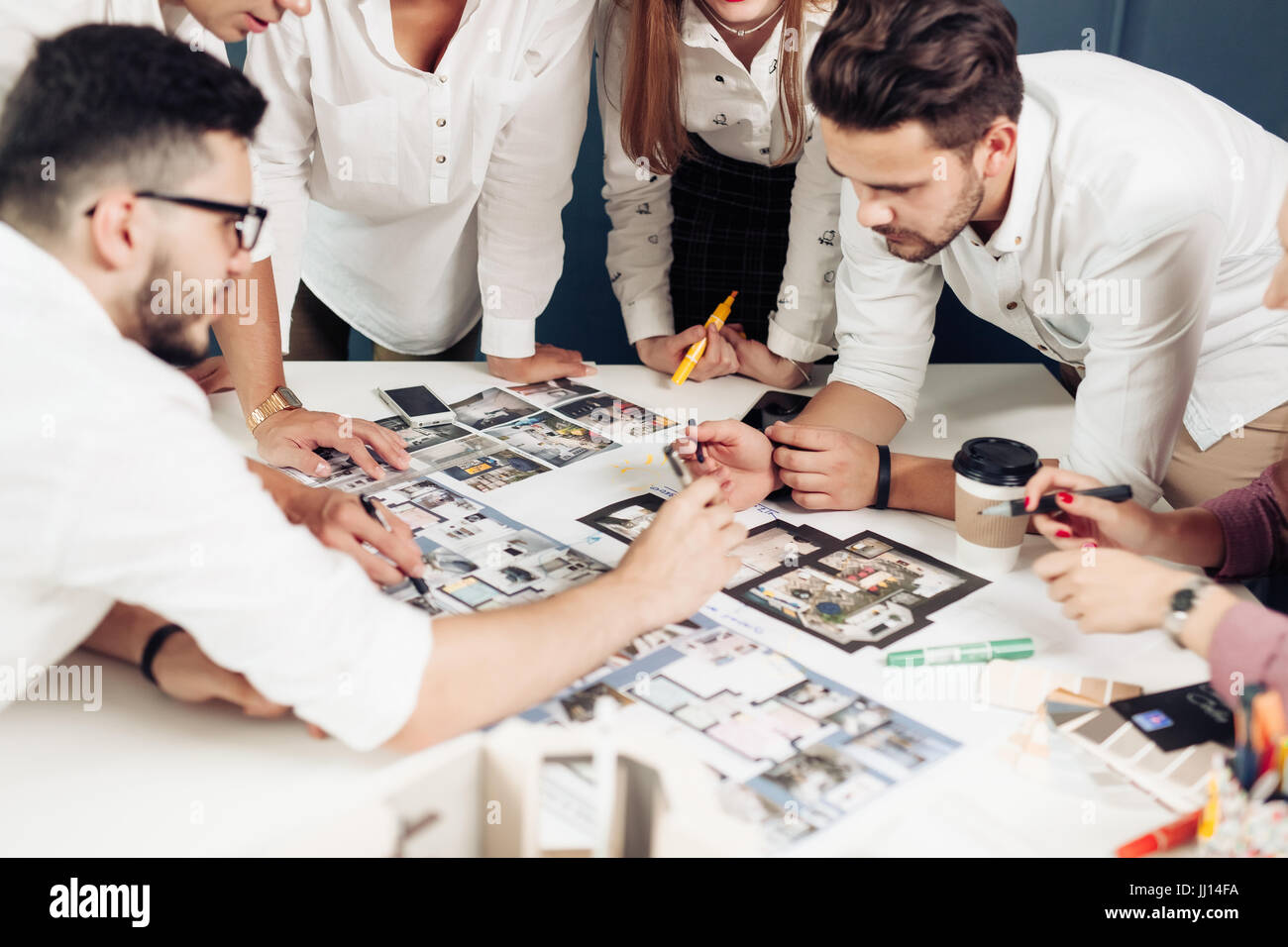 Team of architects working on construction plans Stock Photo - Alamy