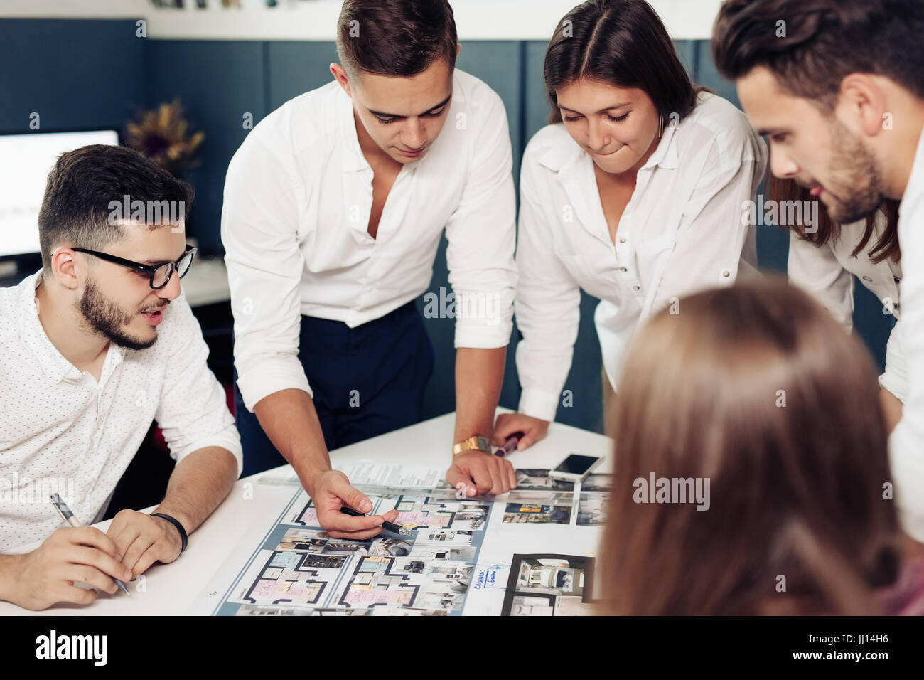 Team of architects working on construction plans Stock Photo - Alamy
