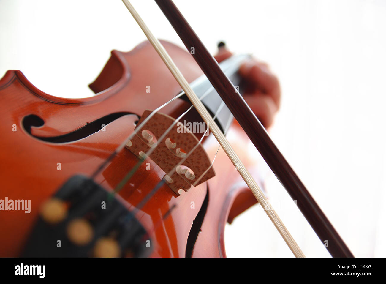 Hand playing the violin from musician point of view. White background ...