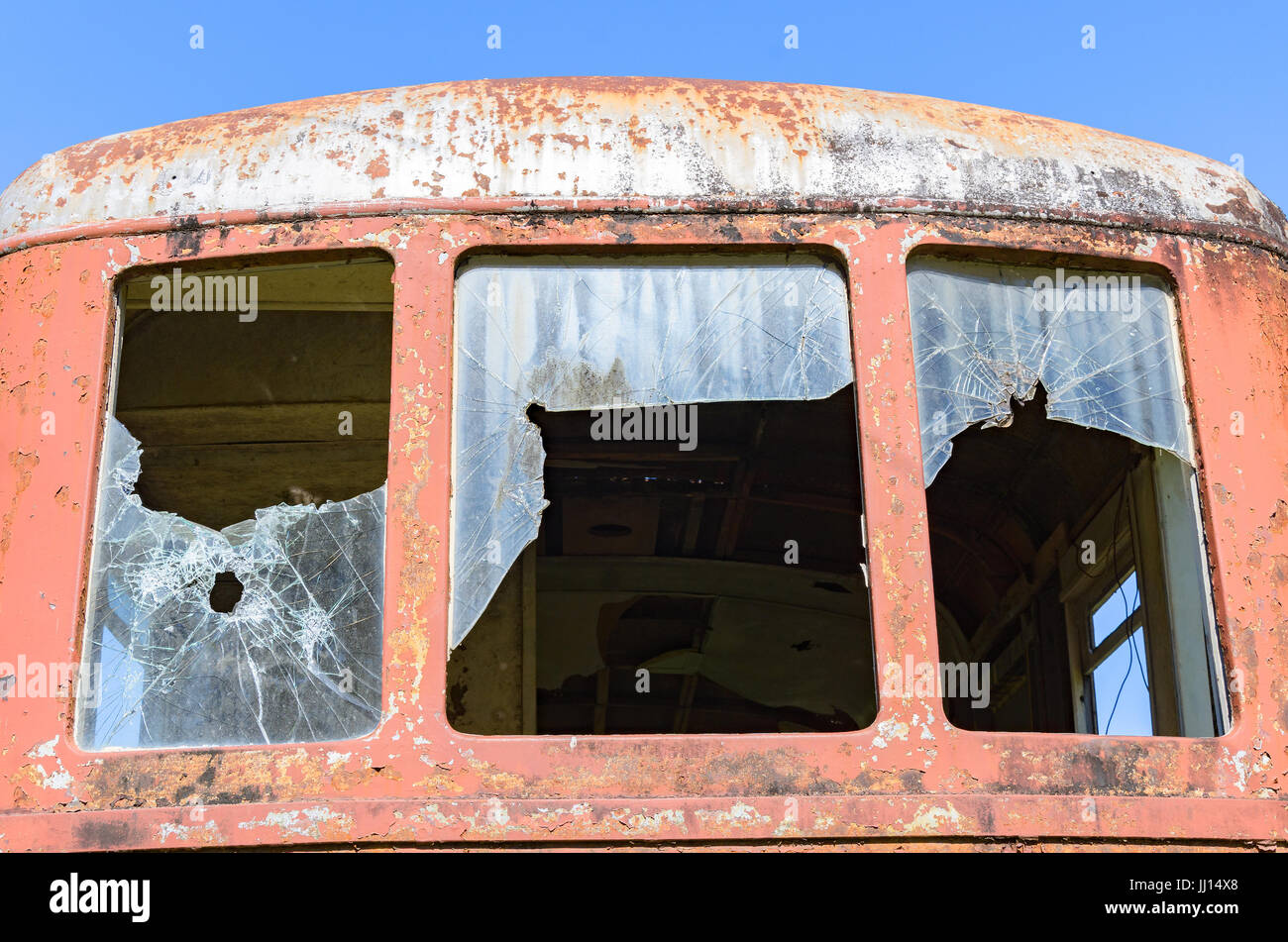 Broken window of a red rusted train, abandoned train Stock Photo - Alamy
