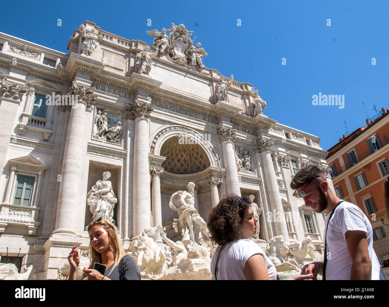 A warm summer day in Rome, with tourists launching as a tradition ...