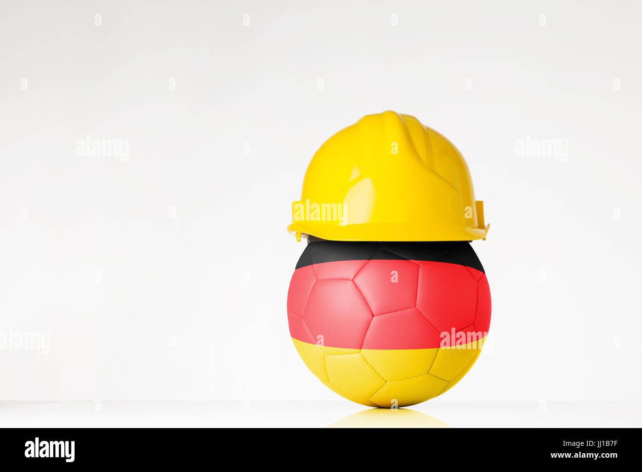 still life image of football wearing a hard hat with the Germany flag ...