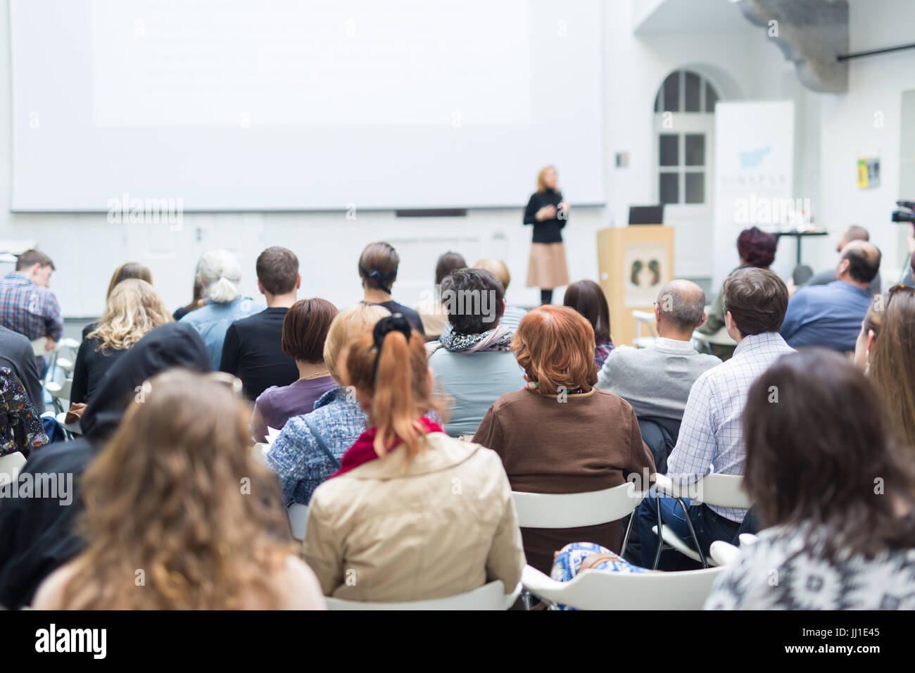 Woman giving presentation in lecture hall at university Stock Photo - Alamy