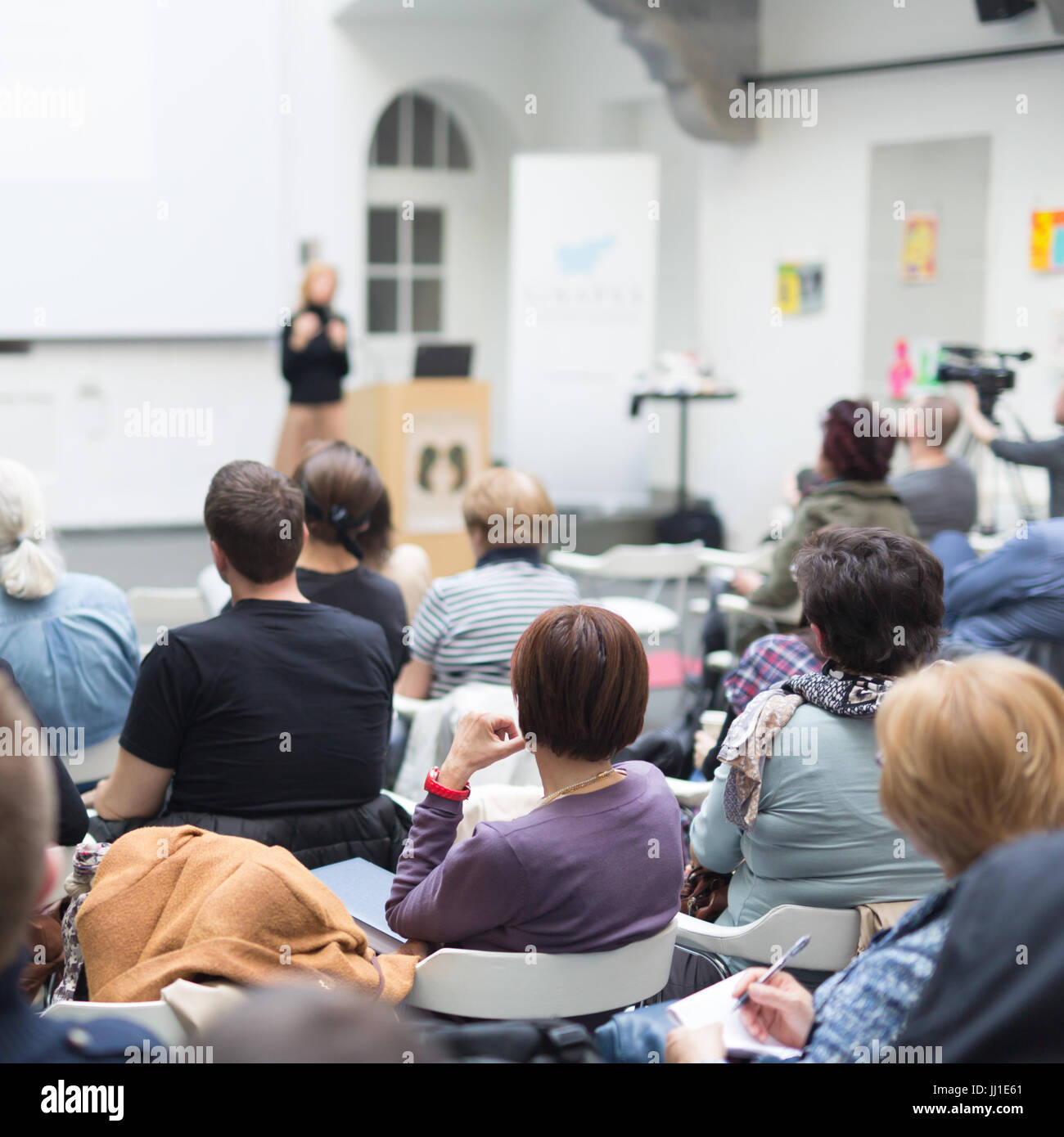 Woman giving presentation in lecture hall at university Stock Photo - Alamy