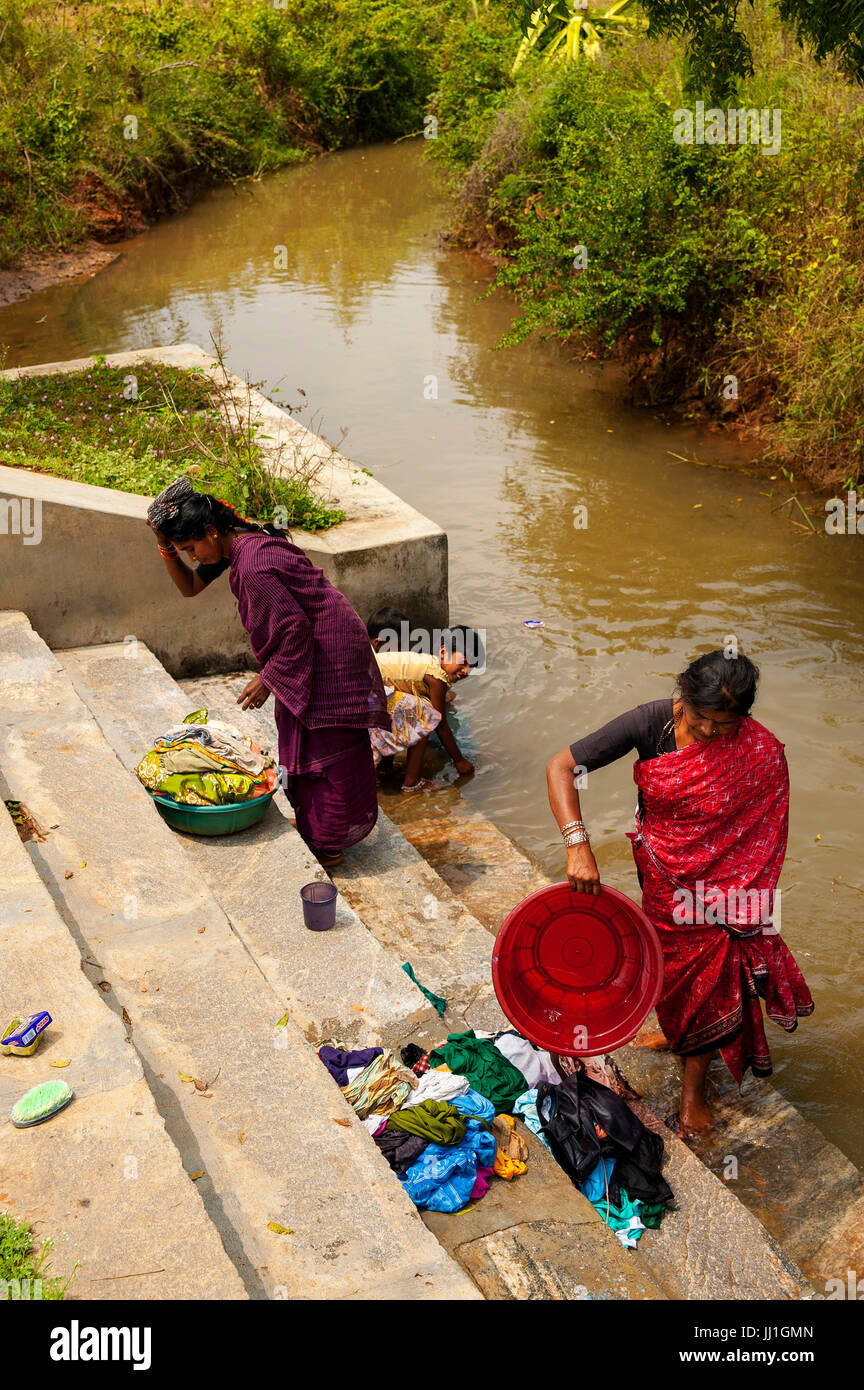 Indian womans washing clothes at a small river, Karnataka, India Stock ...