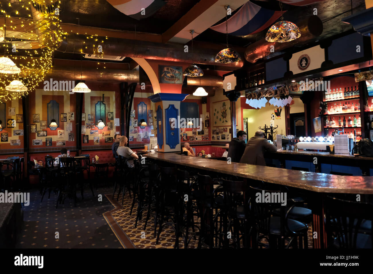 People drink beer in Harat's Irish Pub in the city of Yuzhno-Sakhalinsk, in the island of ...
