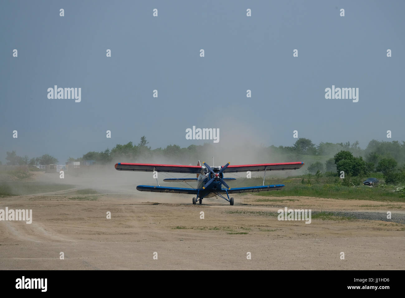 An old single-engine biplane Antonov An-2 aircraft taking off from an ...