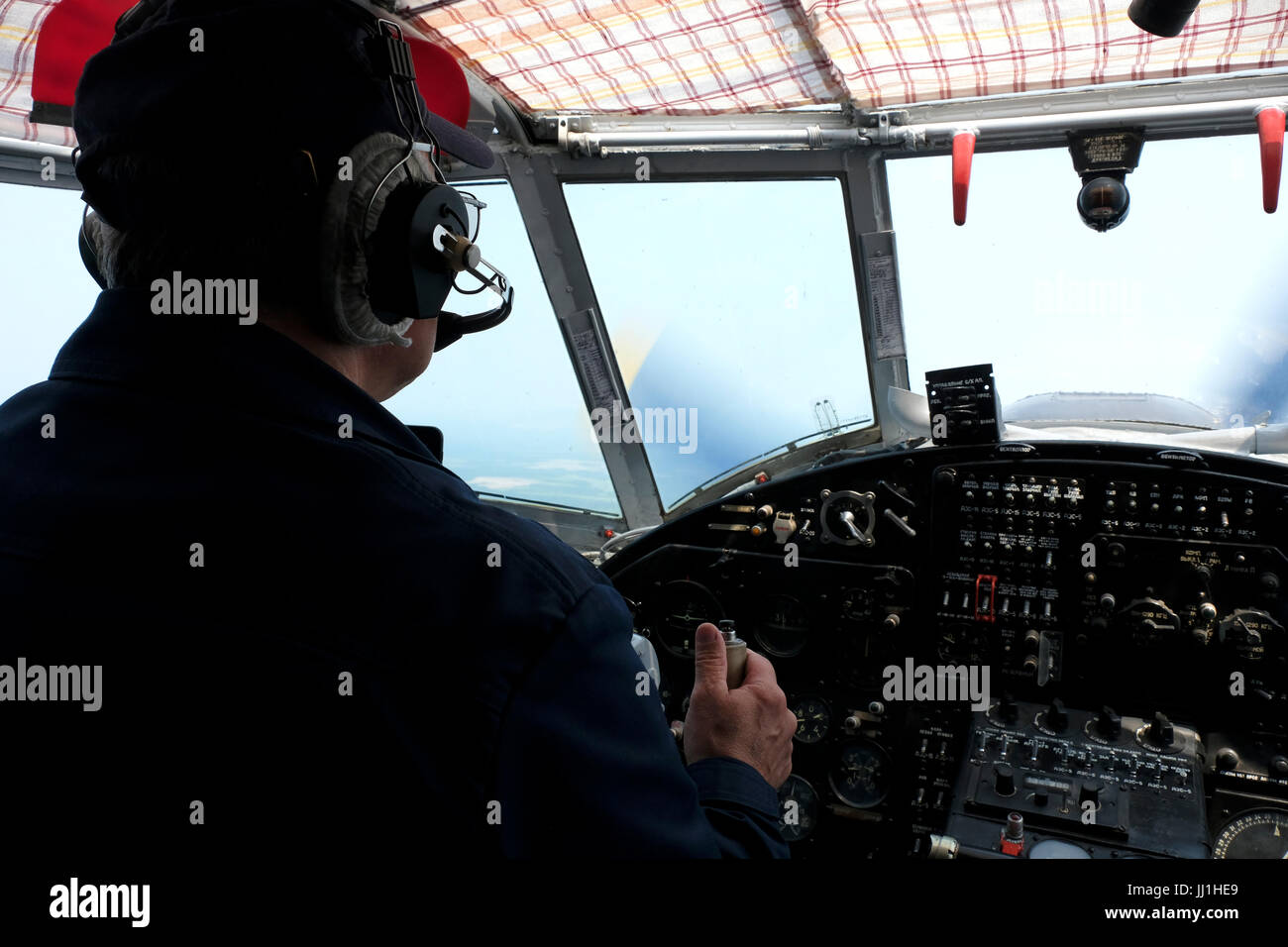 A Russian pilot operates flight control inside a cockpit of an old ...