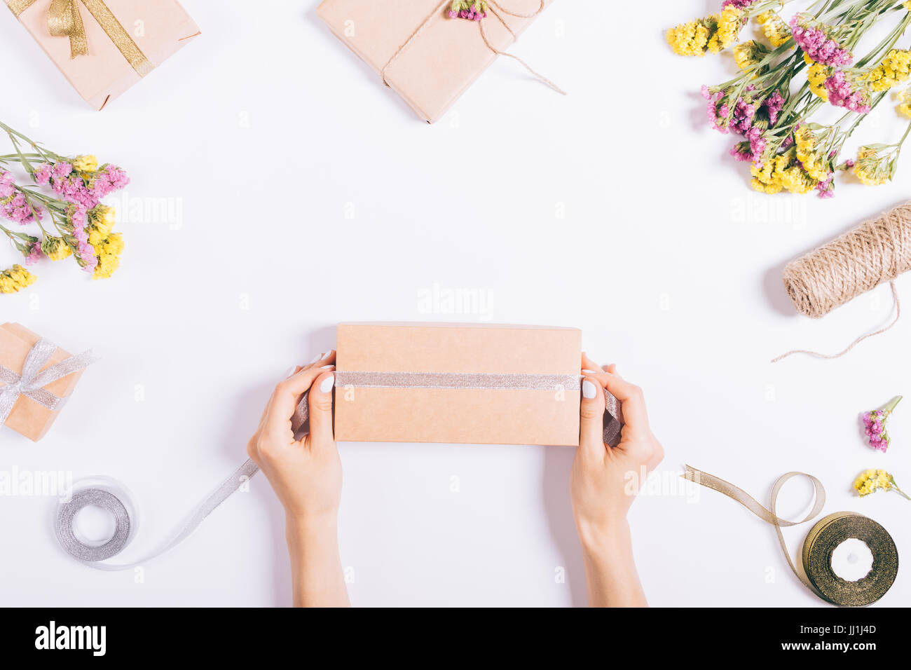 Female hands make holiday decorations on a white table top view Stock ...