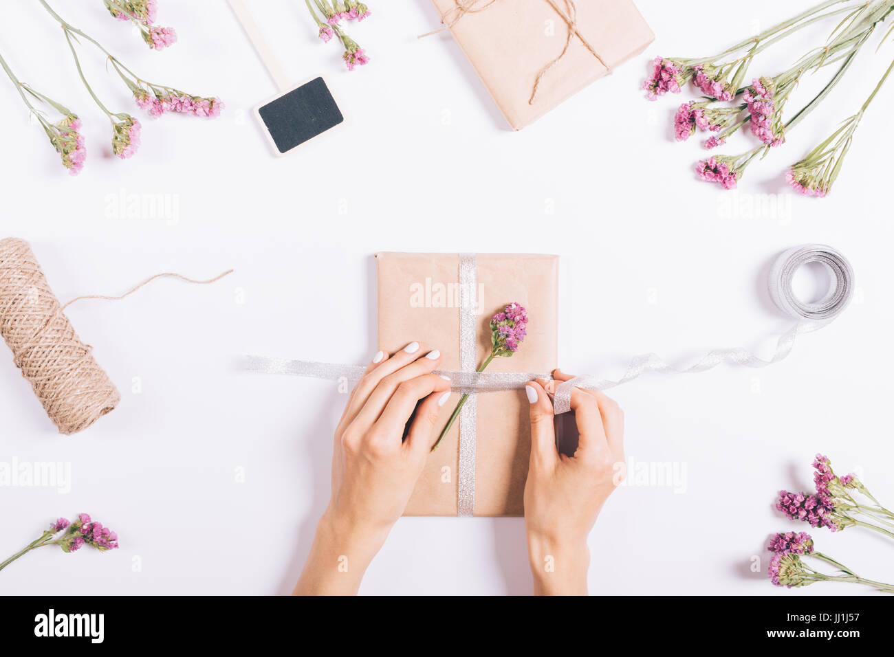 Female hands make festive decorations on white table, top view Stock ...