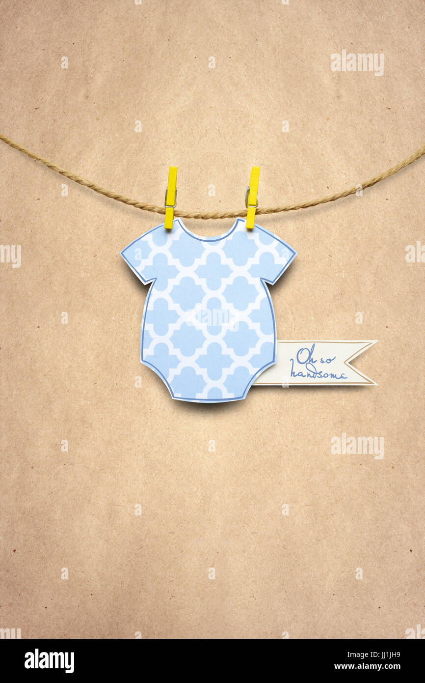 Creative concept photo of a childs jumpers made of paper on brown ...