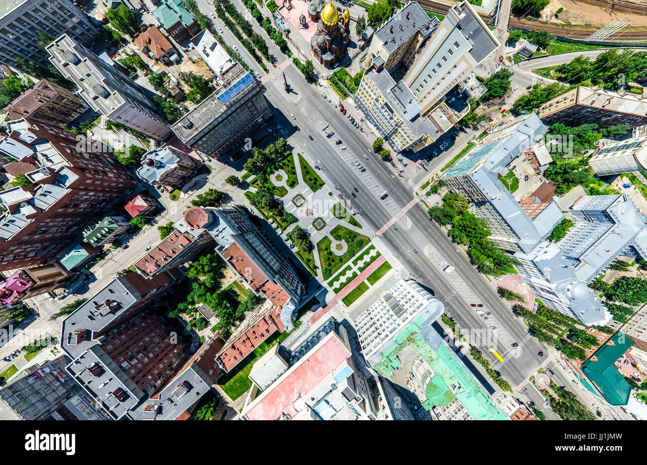 Aerial city view with crossroads and roads, houses, buildings, parks ...