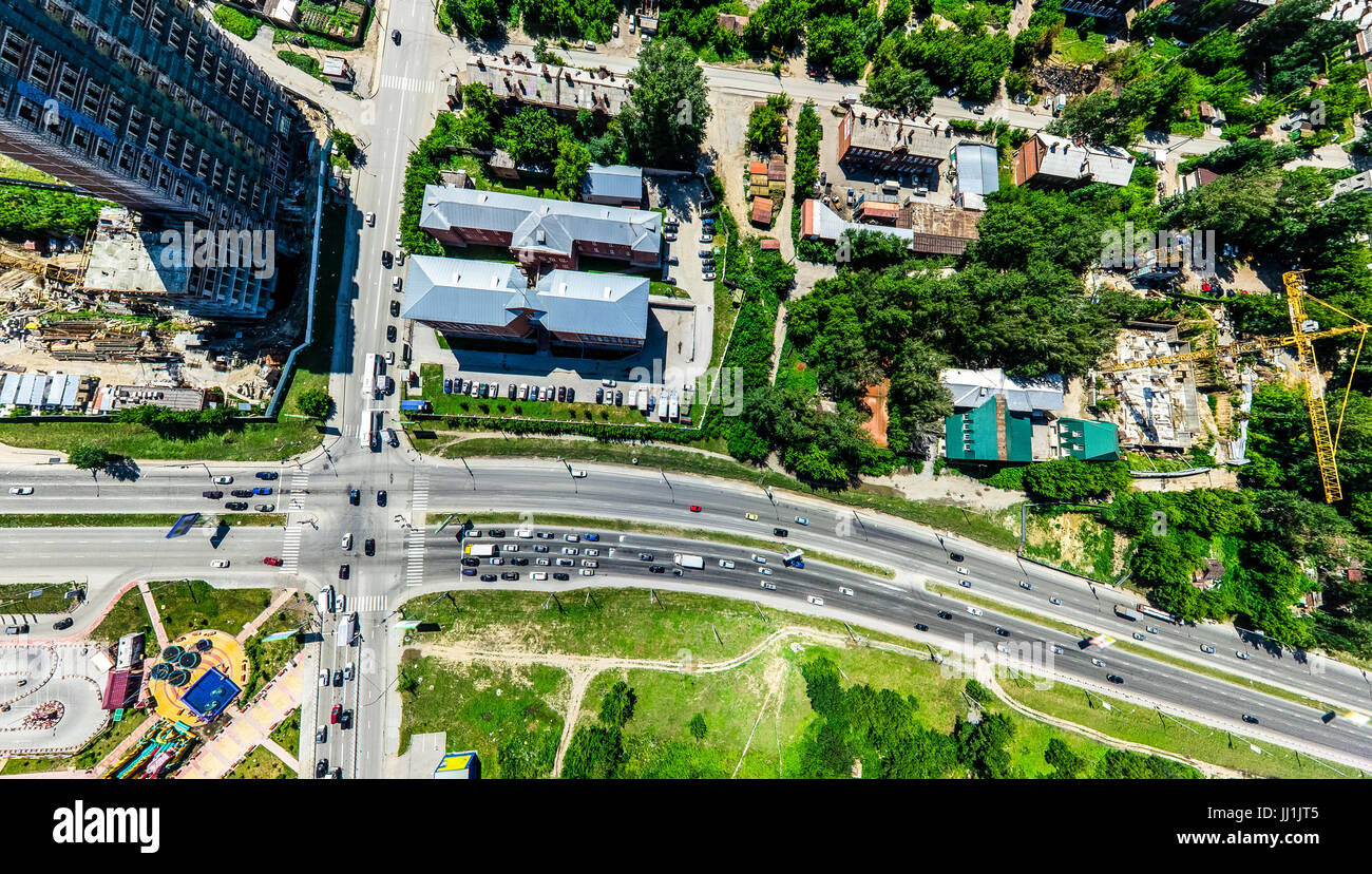 Aerial city view with crossroads and roads, houses, buildings, parks ...