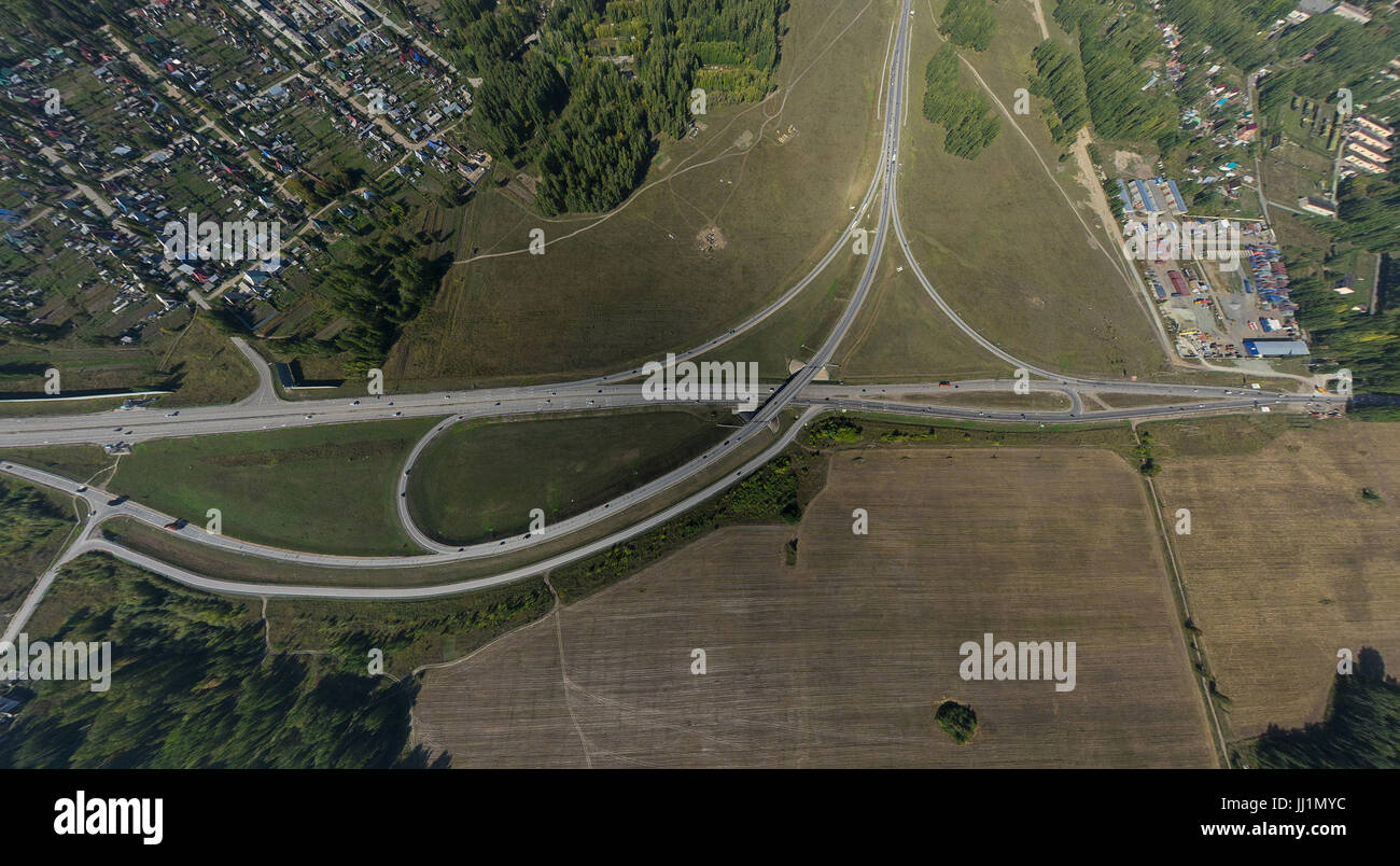 Aerial city view with crossroads, roads, houses, buildings, parks ...