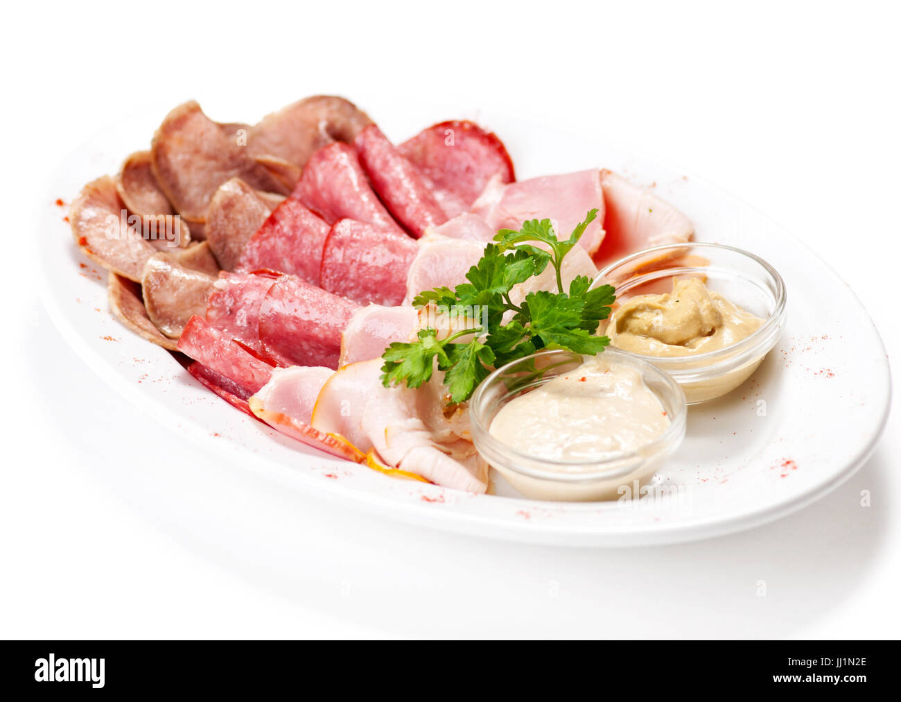 Meat delicatessen plate with souce Stock Photo - Alamy