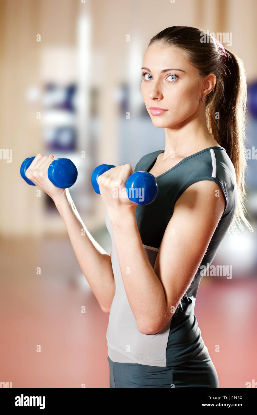 Beautiful sport woman doing exercise with dumbbell Stock Photo - Alamy