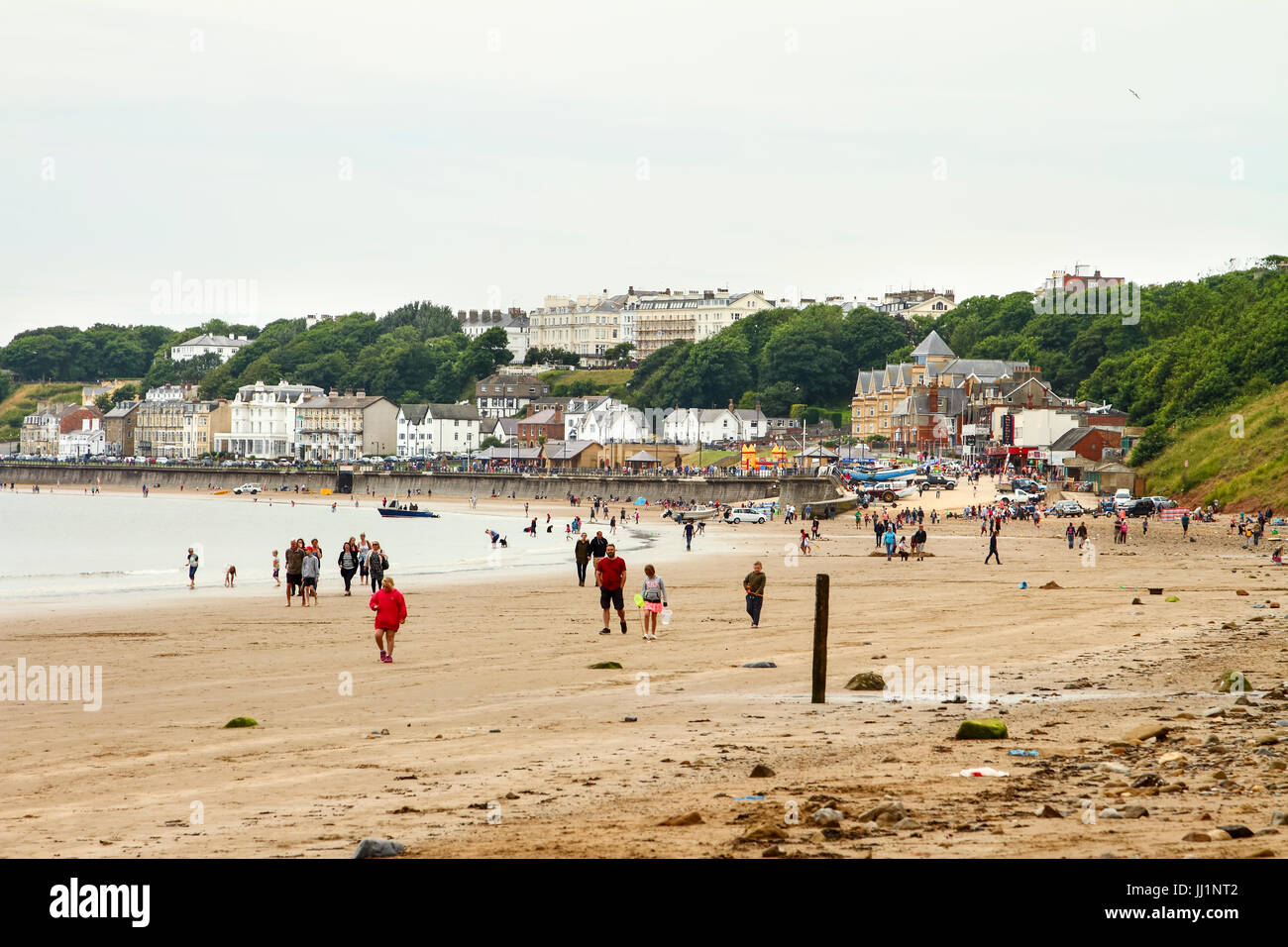 Holiday makers walking on filey beach in the summer Stock Photo - Alamy