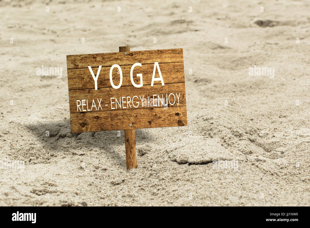 Yoga wooden sign on a sand beach. Relax, energy and enjoy concept Stock ...