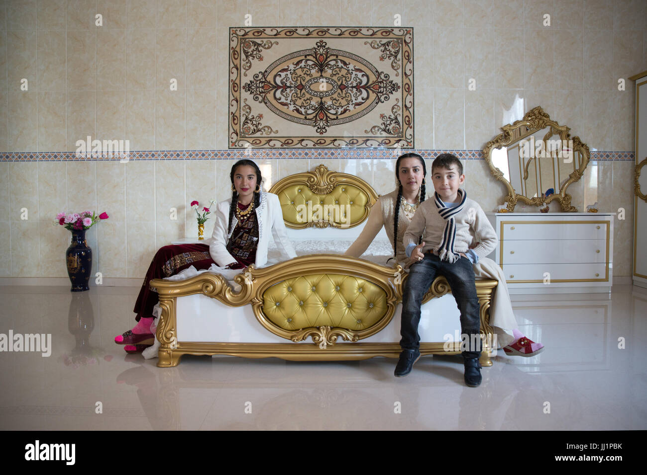 Kids of a wealthy Roma gypsy family posing in the luxurious bedroom of ...