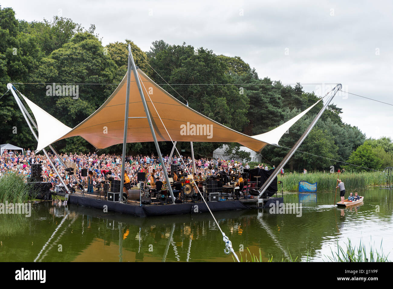 Waterfront stage with dancers, musicians and audience behind. Punt ...