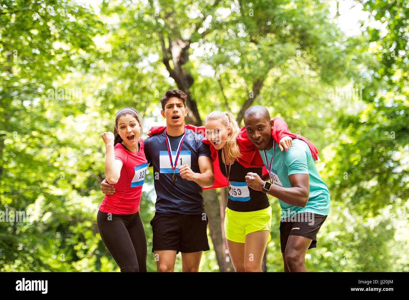 Group of young fit friends happy after finishing race Stock Photo - Alamy