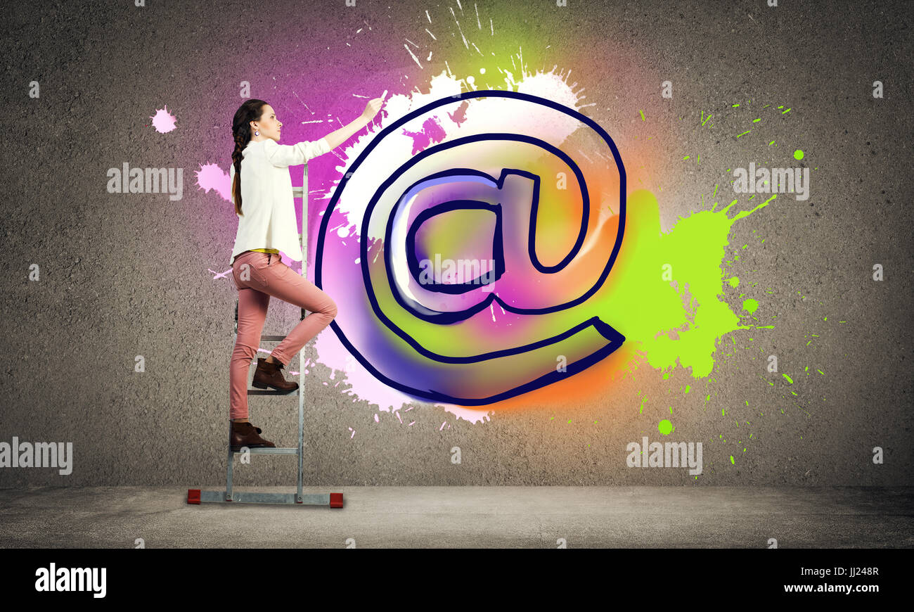 Girl paint wall in colors Stock Photo - Alamy