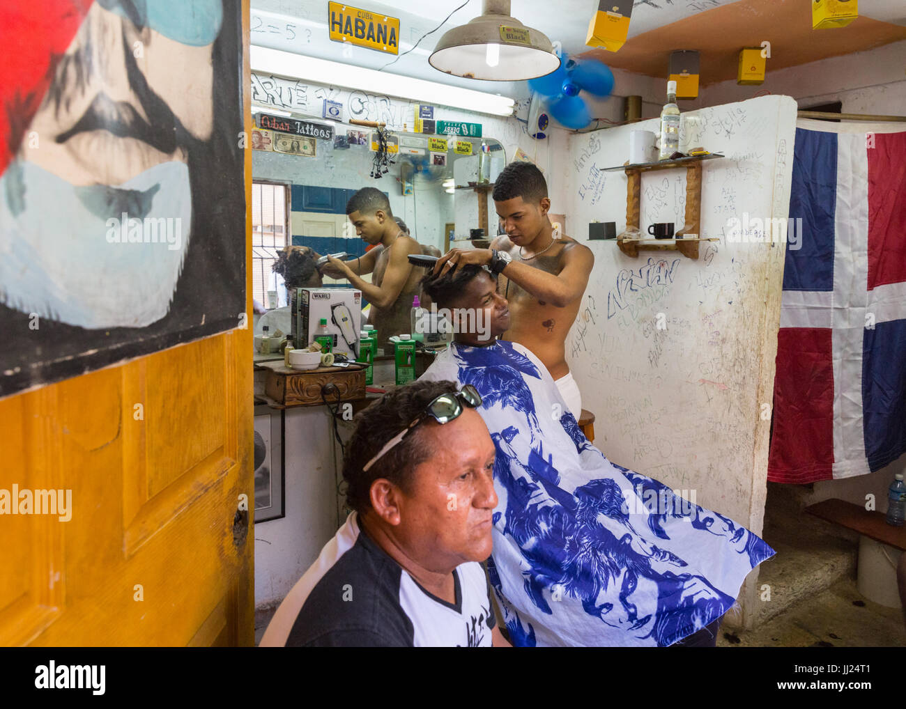 Cuban barber shop and hairdressing salon, hairdresser cut's a clients ...