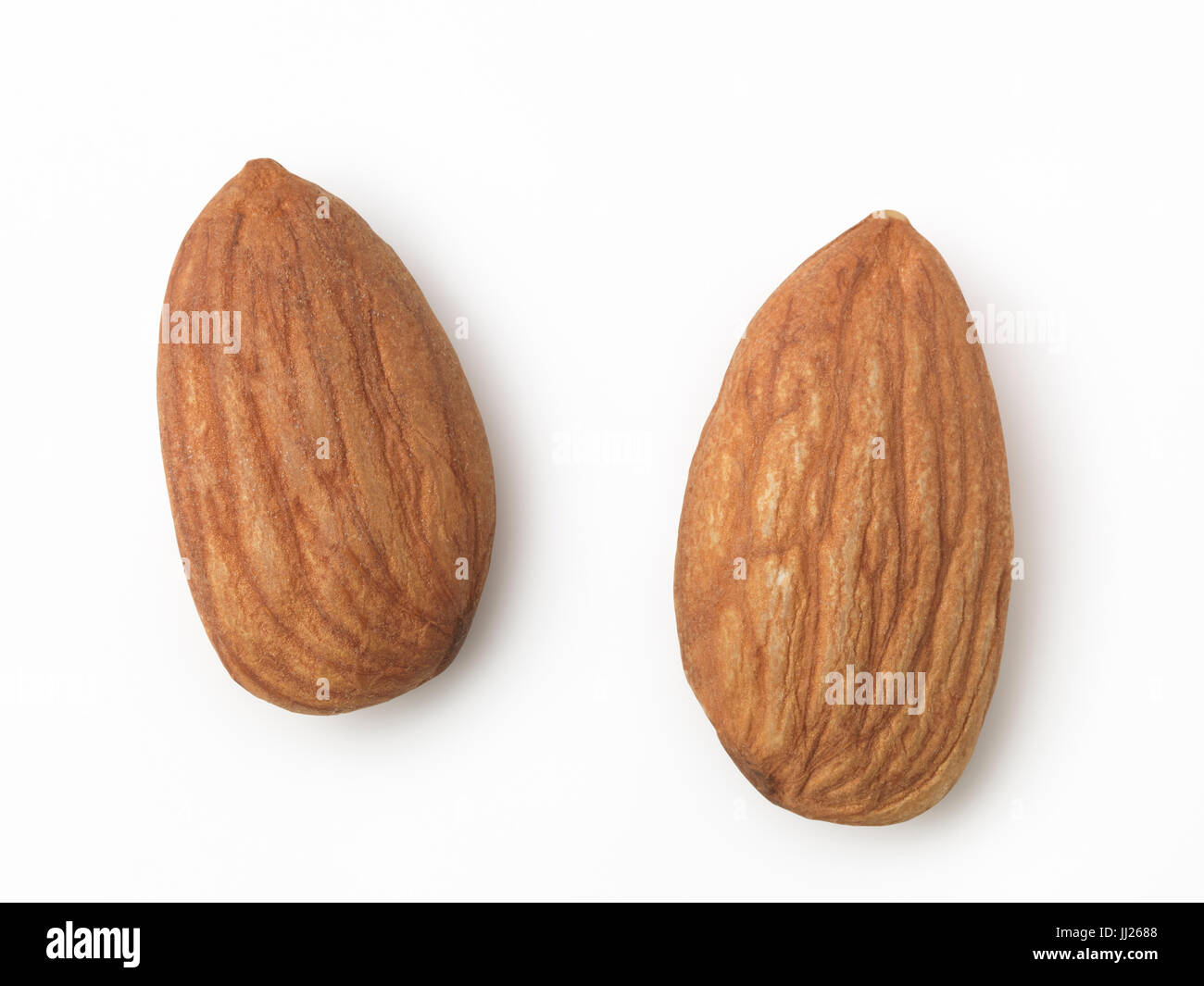 Closeup of two shelled almonds, almond nuts, isolated on white ...