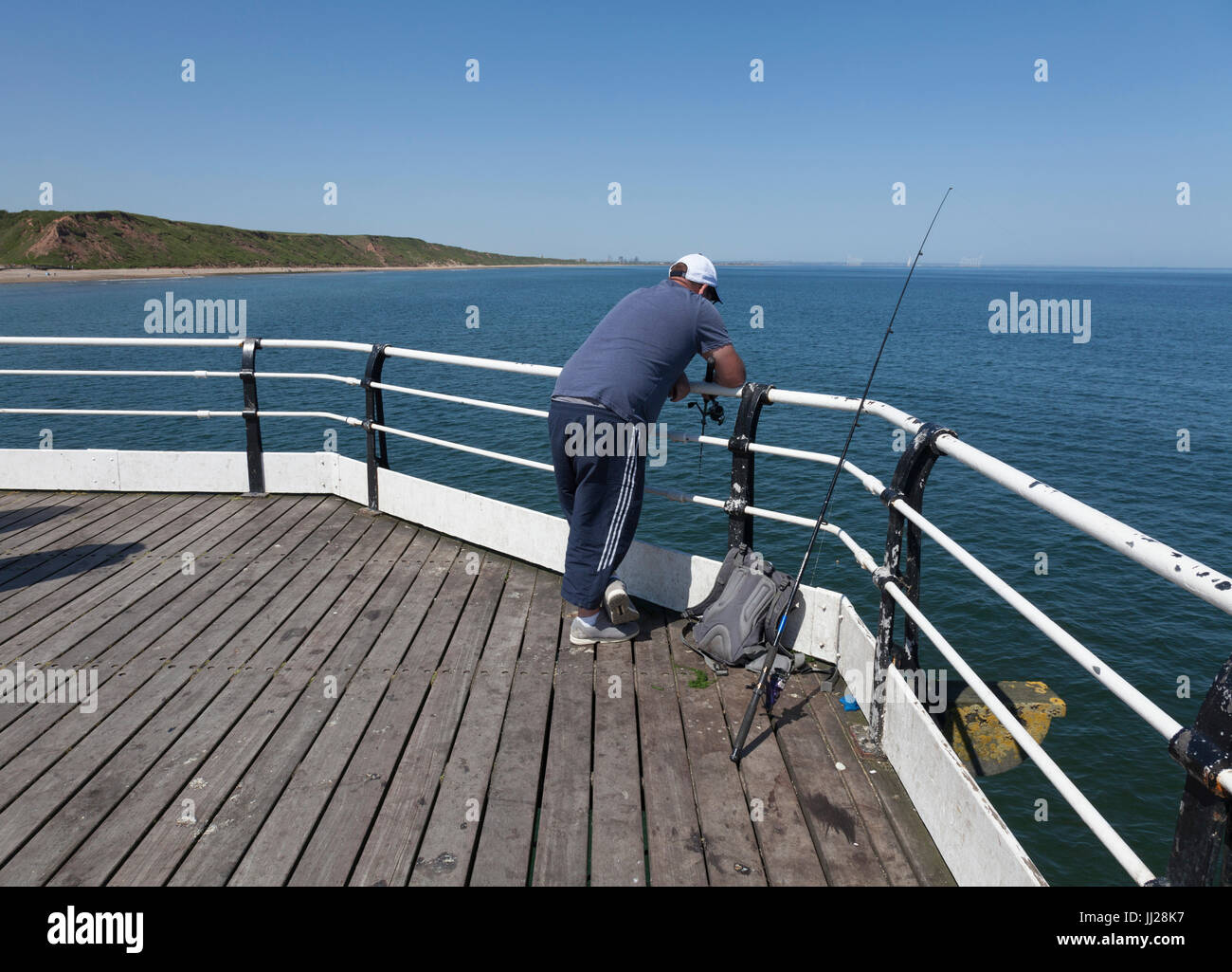 A man stood on the pier fishing at Saltburn by the Sea,England,UK Stock ...